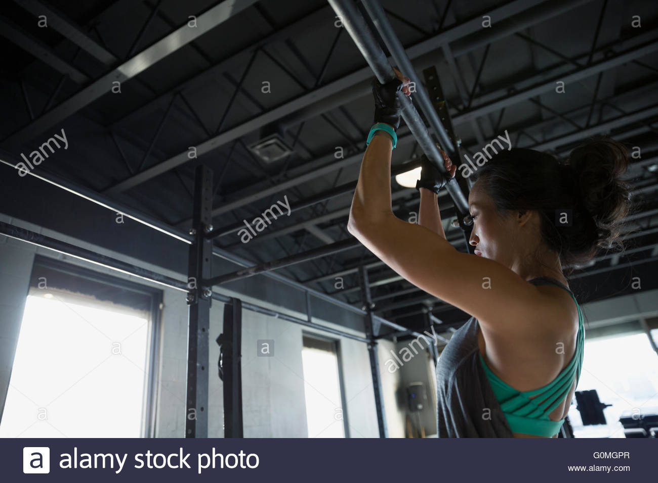 Fitness girl doing pull ups hi-res stock photography and images - Alamy