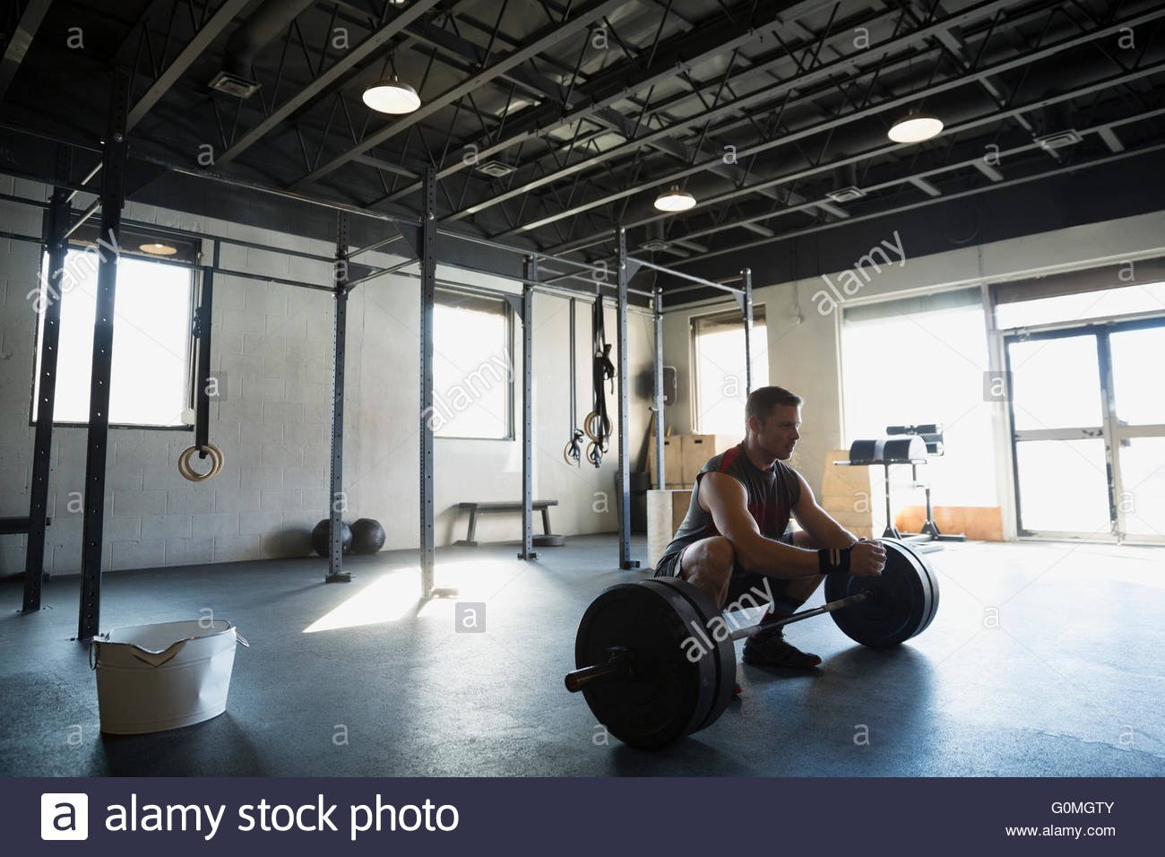 Squatting men hi-res stock photography and images - Alamy