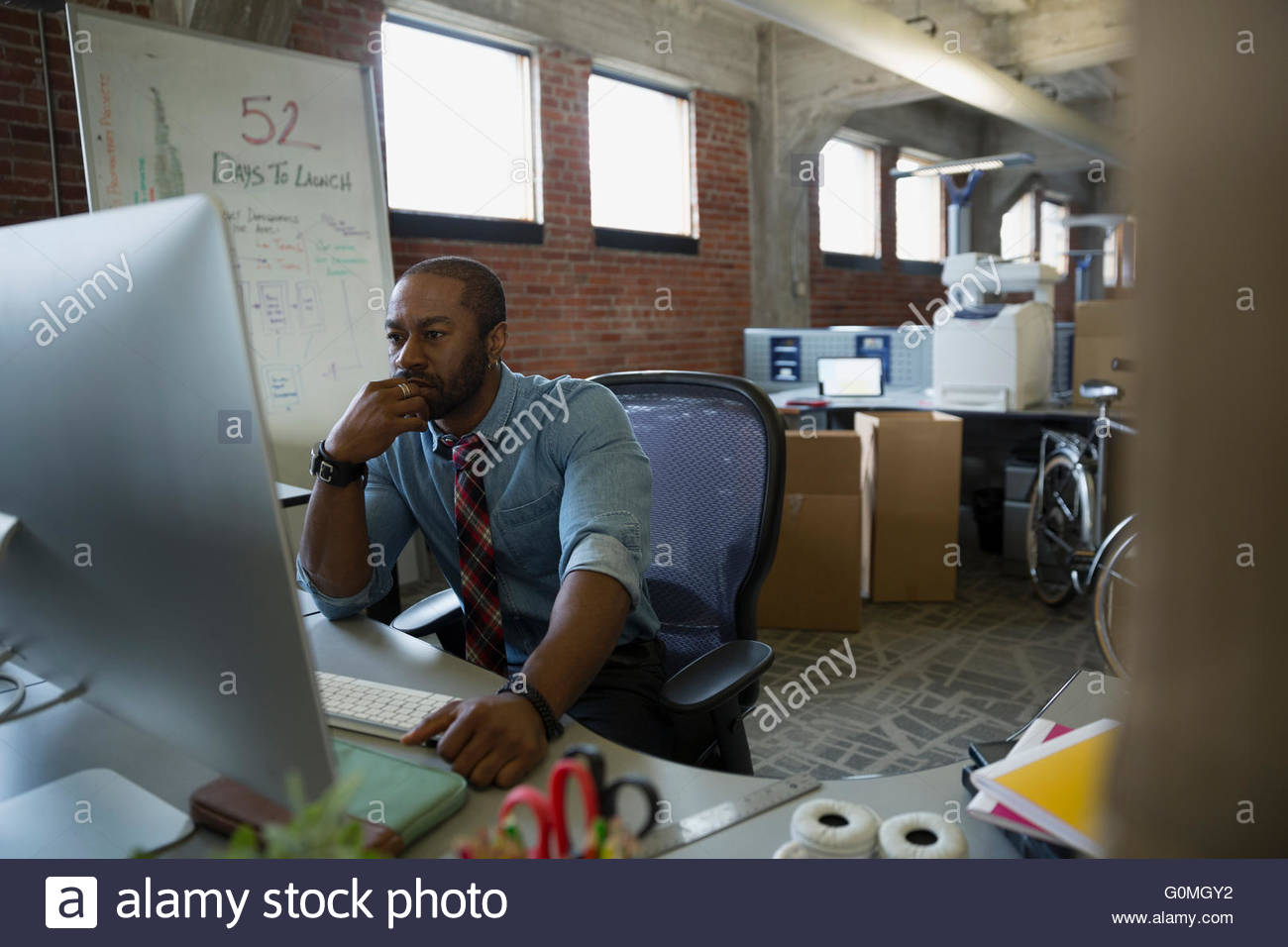 Entrepreneur using computer in new office Stock Photo - Alamy