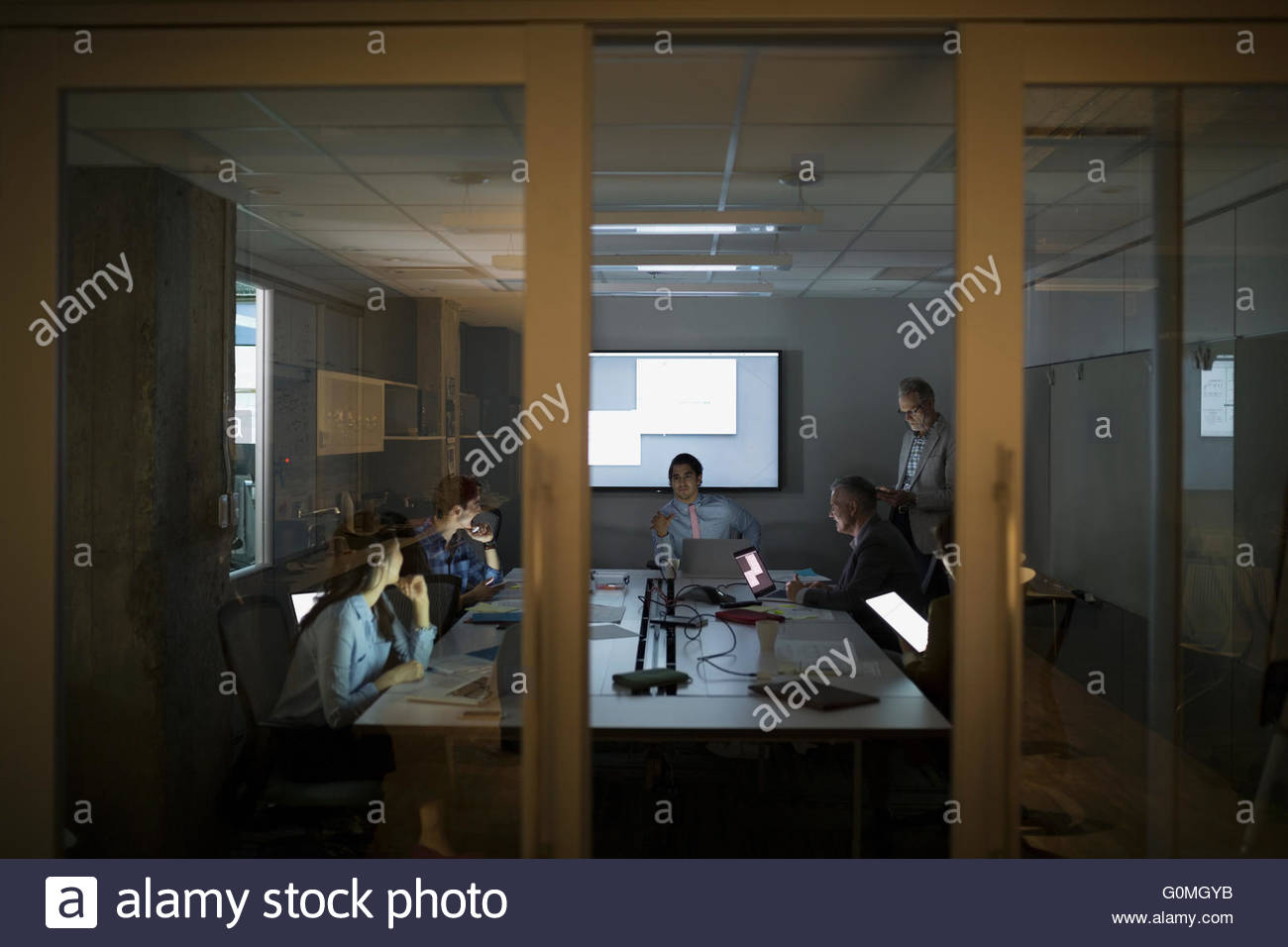 Business people meeting in dark conference room Stock Photo - Alamy