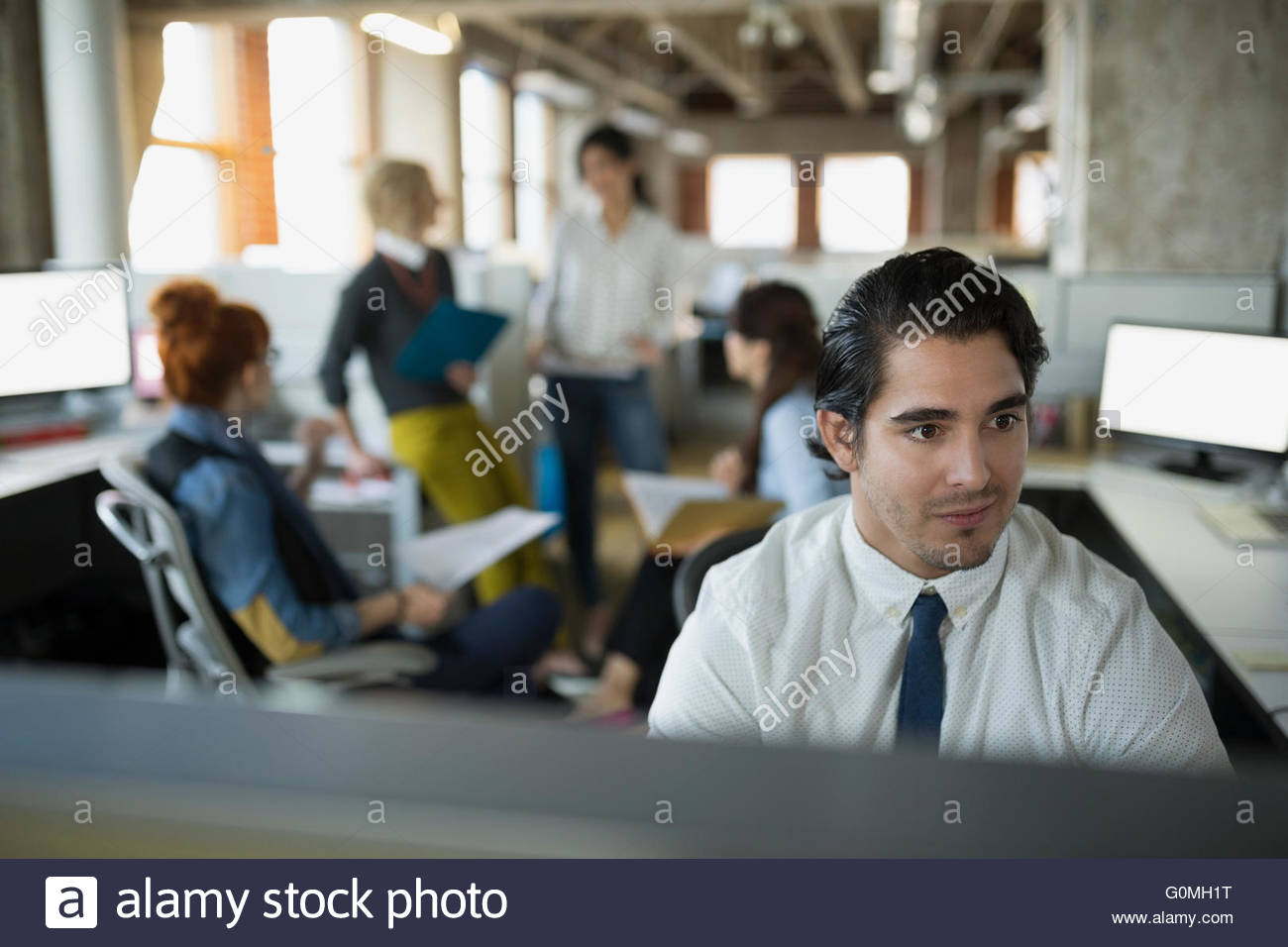 Businessman looking down at computer desk in office Stock Photo - Alamy