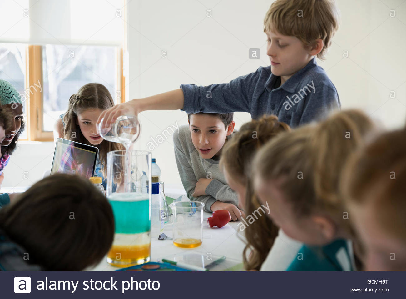 Boys and girls conducting science experiment dining table Stock Photo ...
