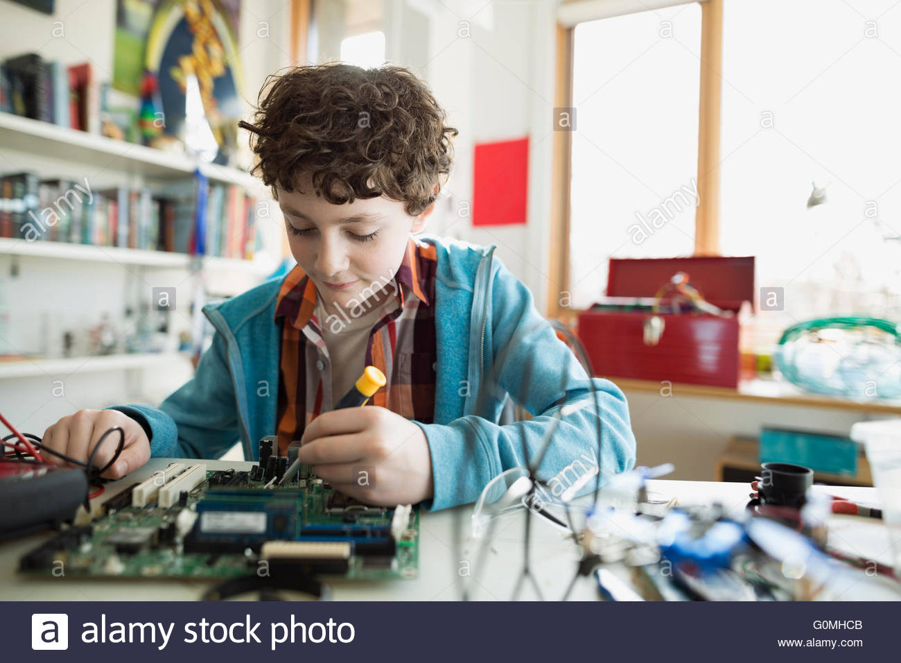 Boy assembling circuit board in bedroom Stock Photo - Alamy