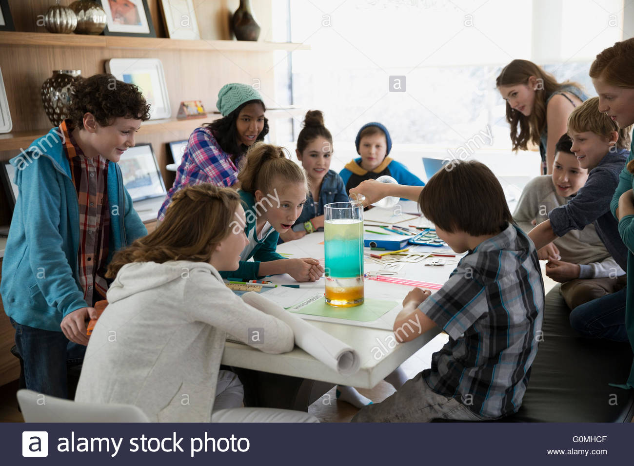 Boys and girls conducting science experiment dining table Stock Photo ...