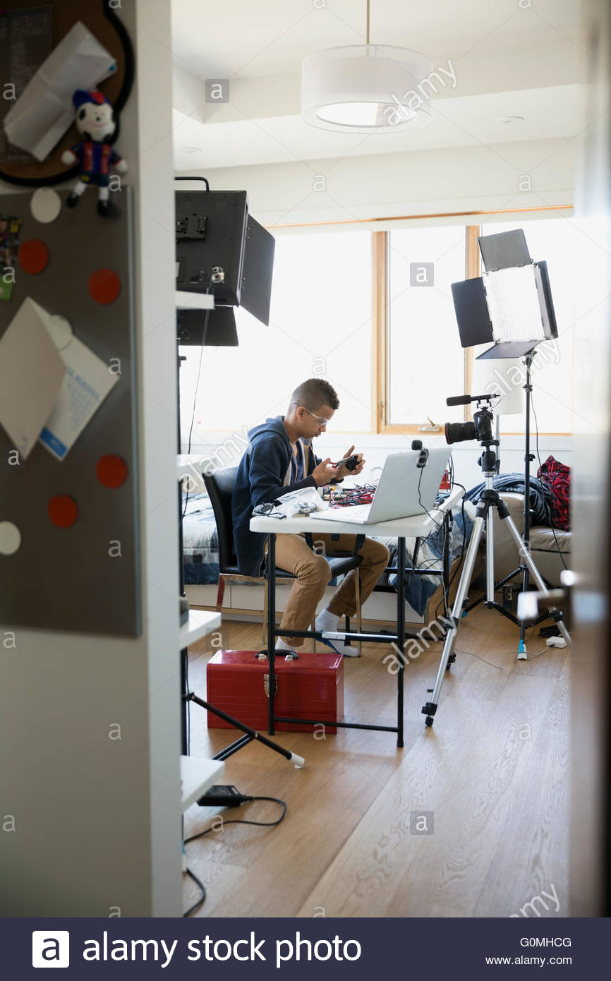 Boy videotaping circuit board assembly in bedroom Stock Photo - Alamy