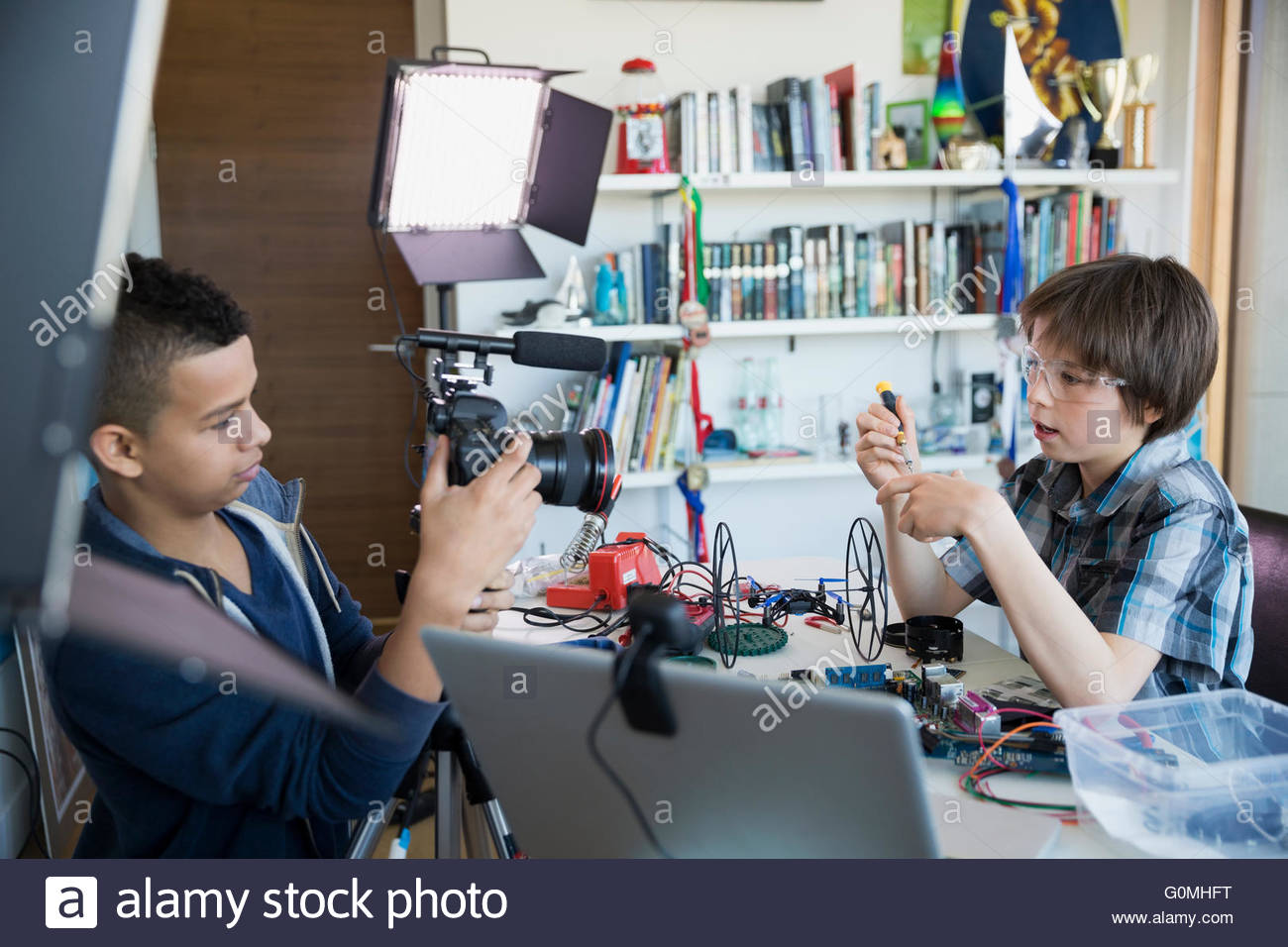 Boys videotaping circuit board assembly in bedroom Stock Photo - Alamy
