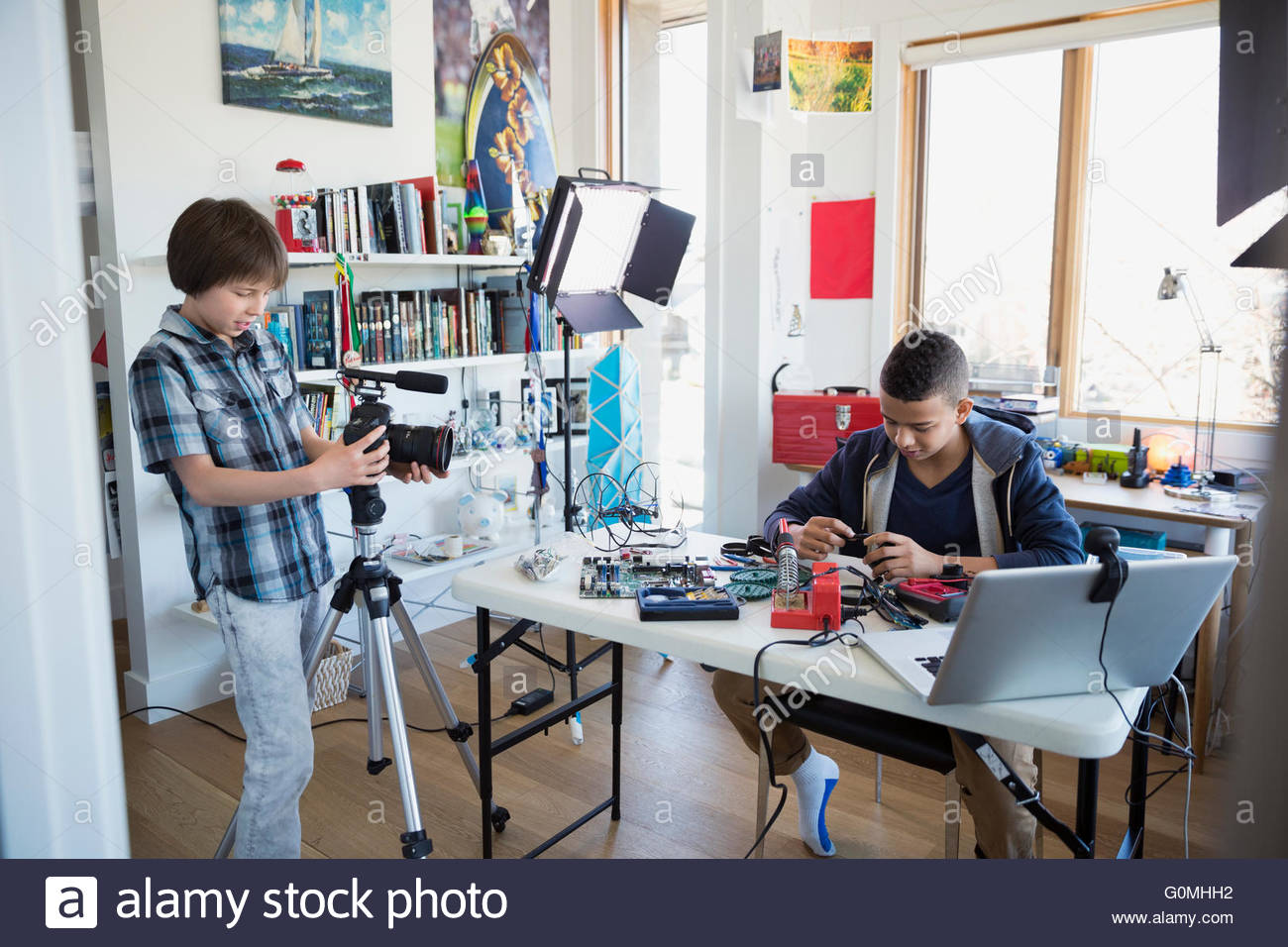 Boys videotaping circuit board assembly in bedroom Stock Photo - Alamy