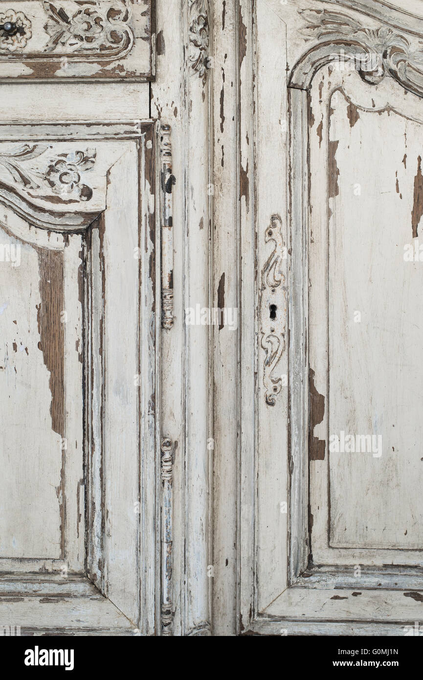 Close-up of keyhole ancient white commode bureau furniture with paint ...