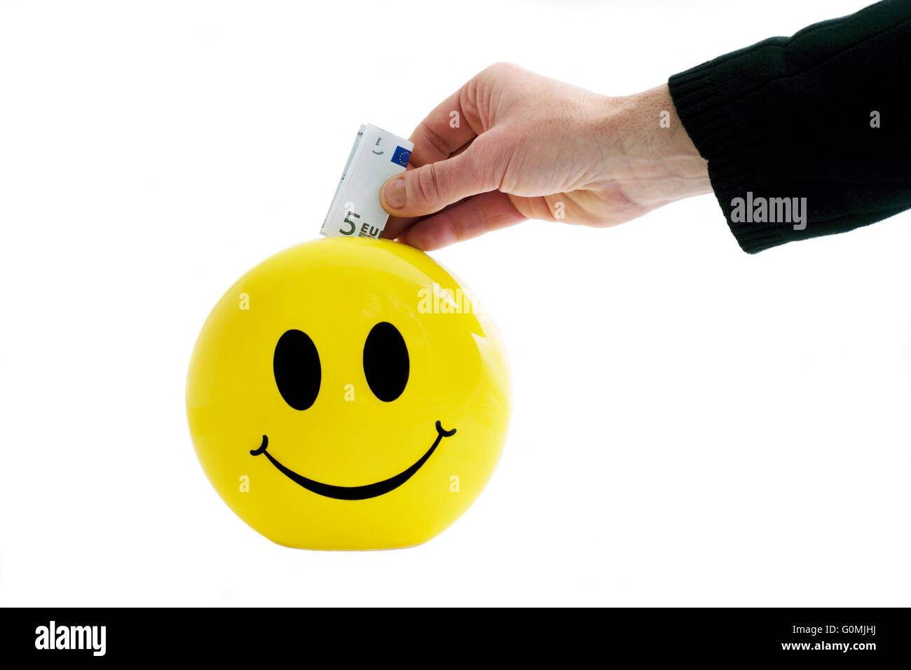 man putting money into a smiley savings box Stock Photo - Alamy