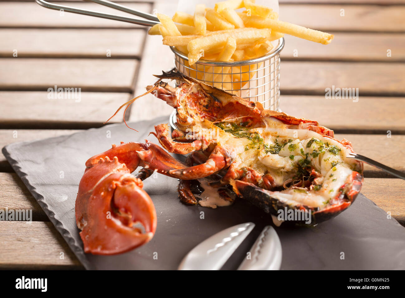 Grilled lobster, herb butter & fries Stock Photo - Alamy