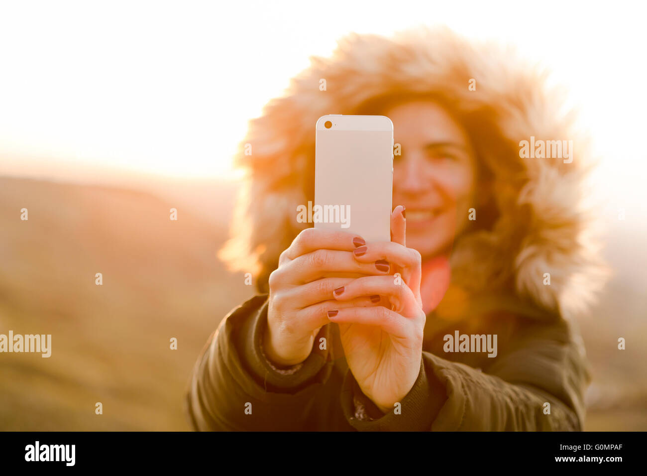 Beautiful woman in outdoor making a selfie Stock Photo - Alamy