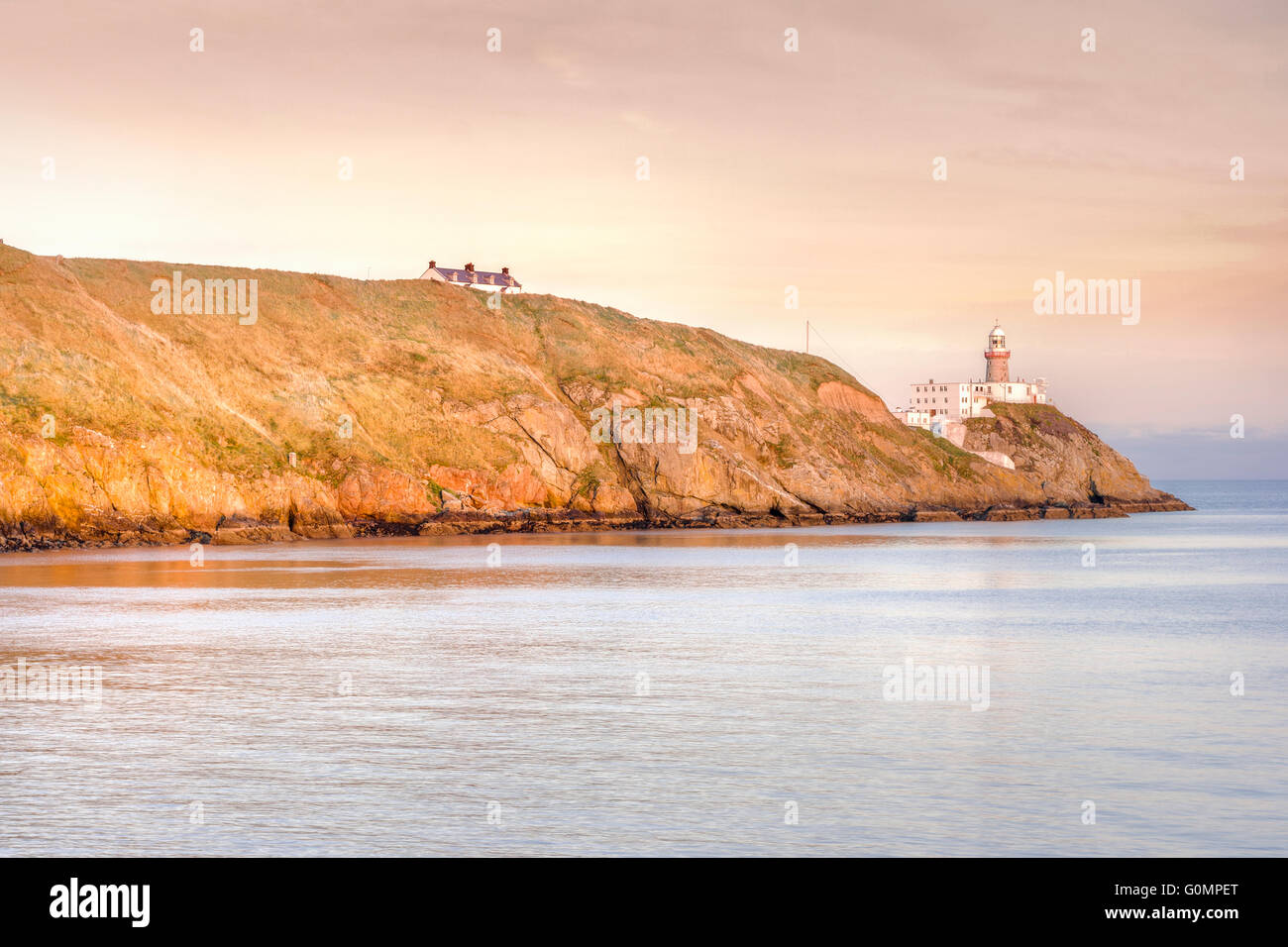 Baily lighthouse at the sunset in Howth peninsula, Dublin, Ireland ...