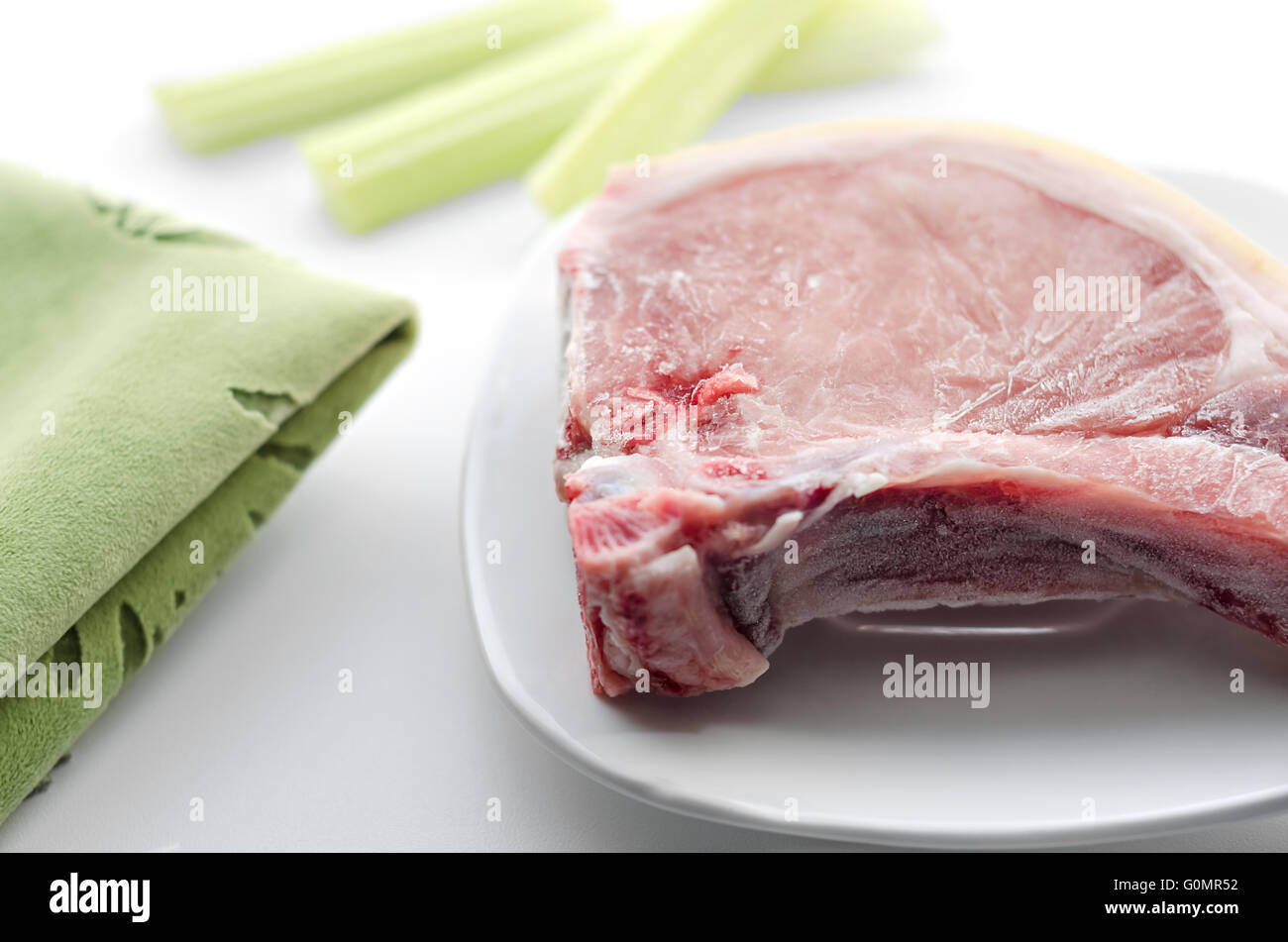 Fresh pork meat on white plate, morning light and bokeh Stock Photo - Alamy