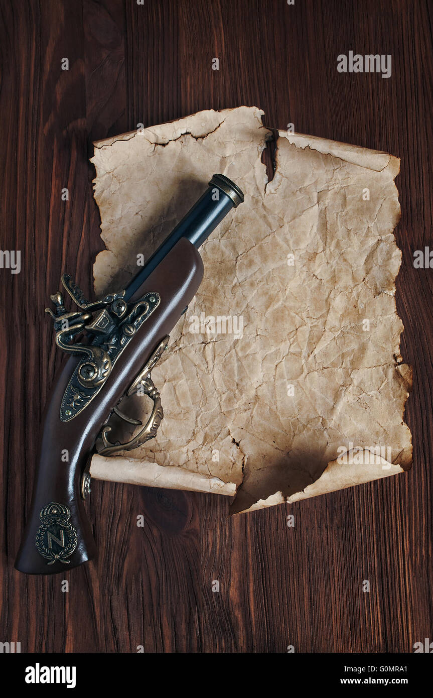 Retro pistol or musket and parchment on a wooden table Stock Photo - Alamy