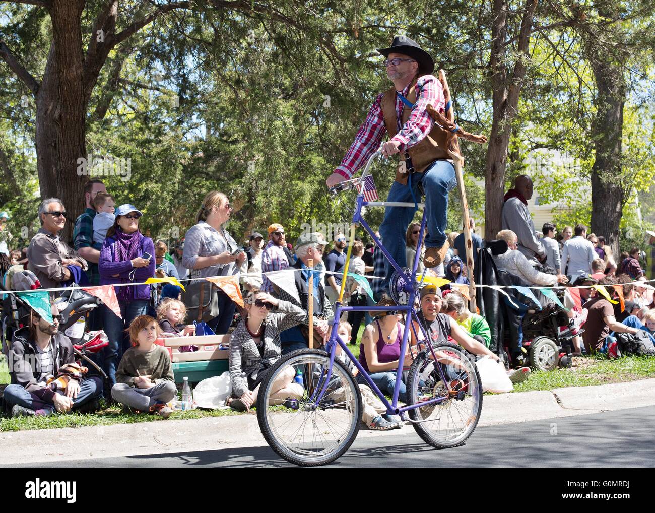 A man on a tall bike at the May Day celebration including parade and ...