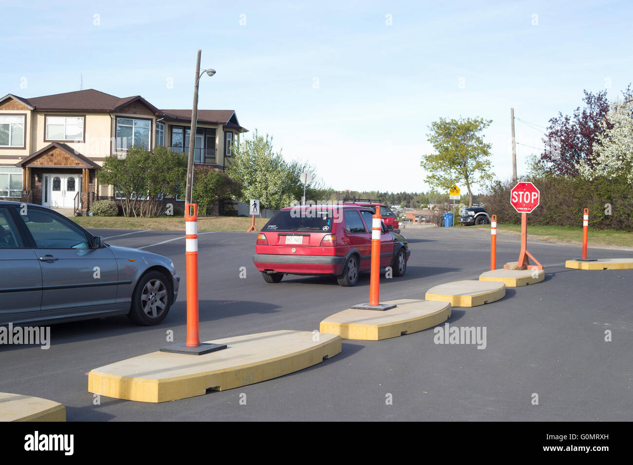 Traffic calming curbs in city street Stock Photo - Alamy