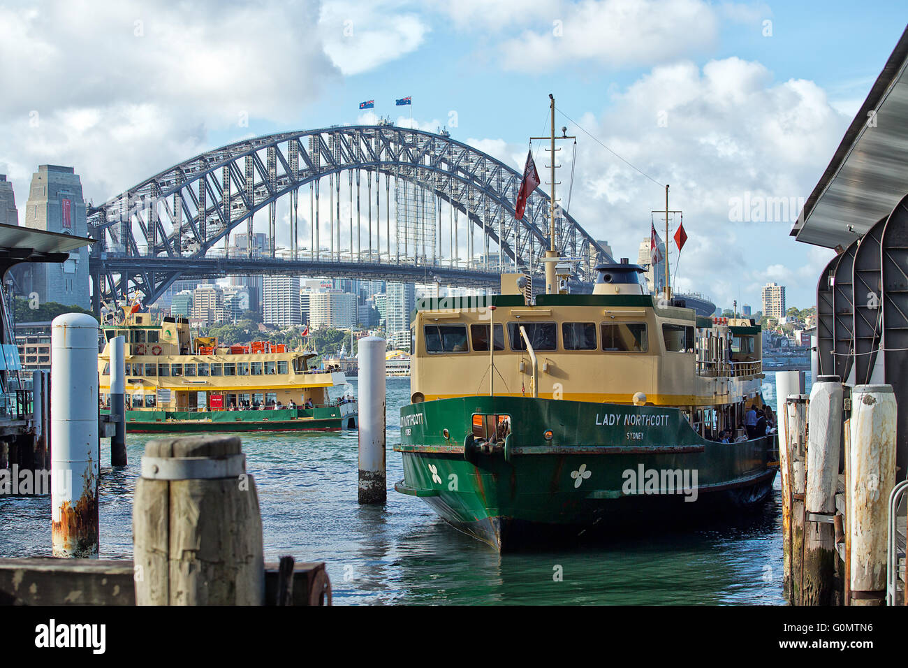 Sydney ferries arriving and departing Circular Quay. Harbour bridge in ...