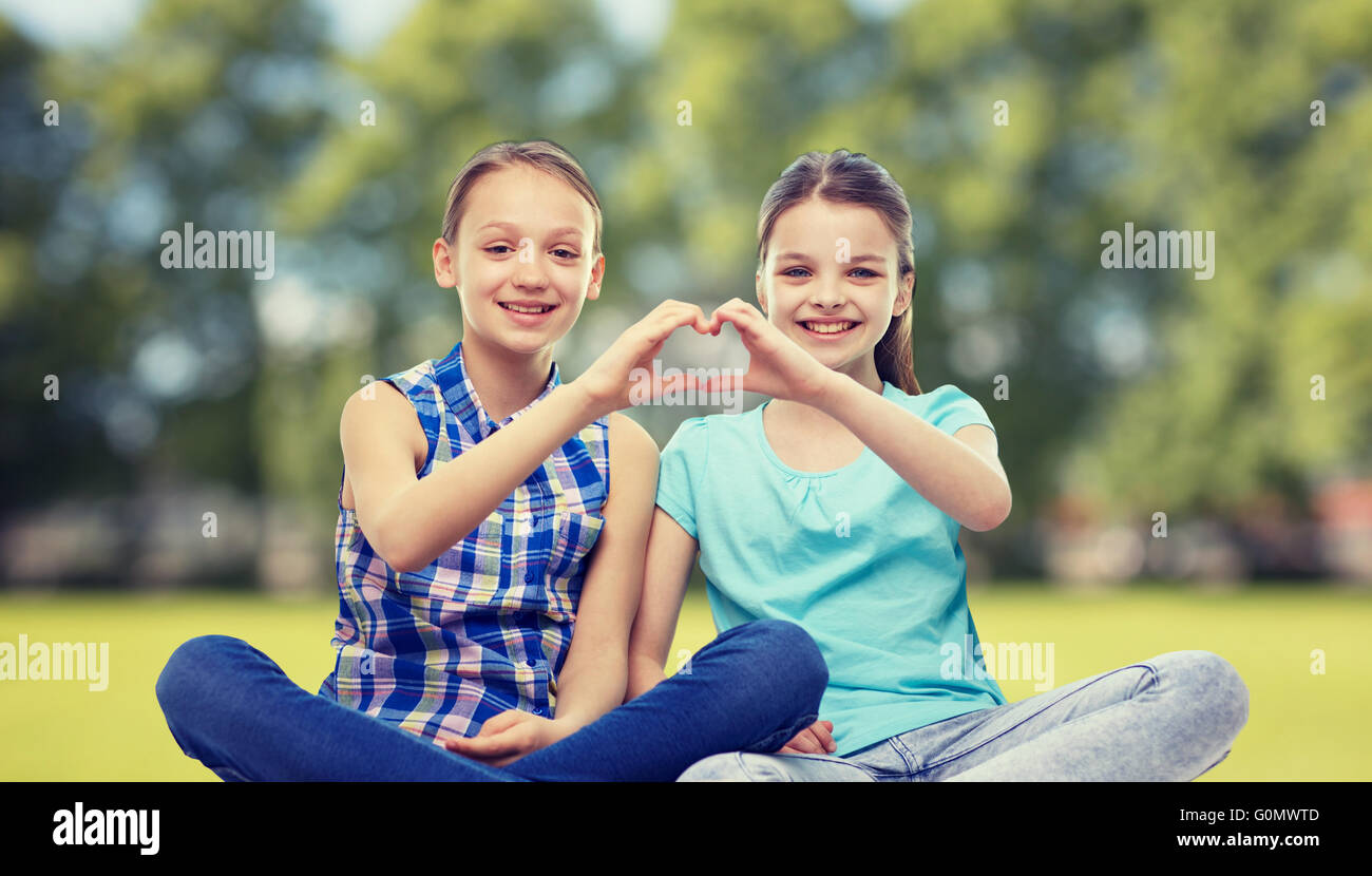 happy little girls showing heart shape hand sign Stock Photo - Alamy