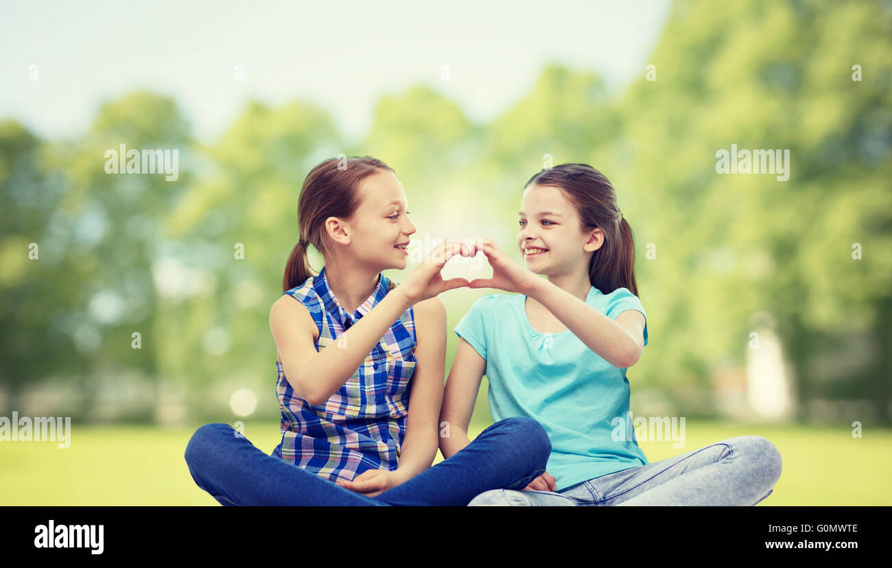 happy little girls showing heart shape hand sign Stock Photo - Alamy