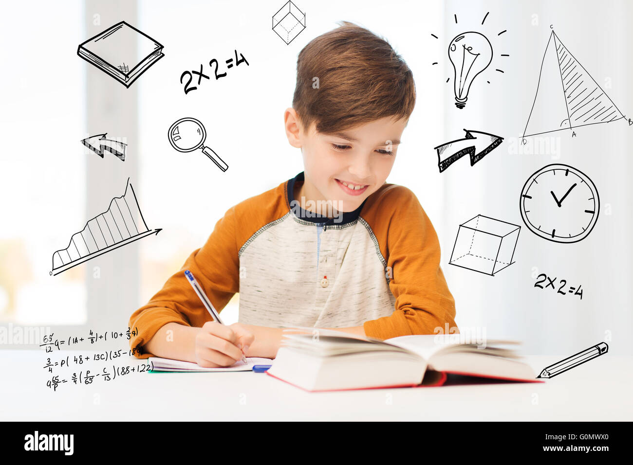 smiling student boy writing to notebook at home Stock Photo - Alamy