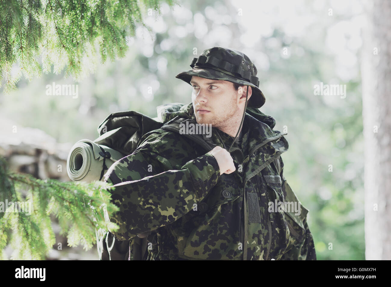 young soldier with backpack in forest Stock Photo - Alamy