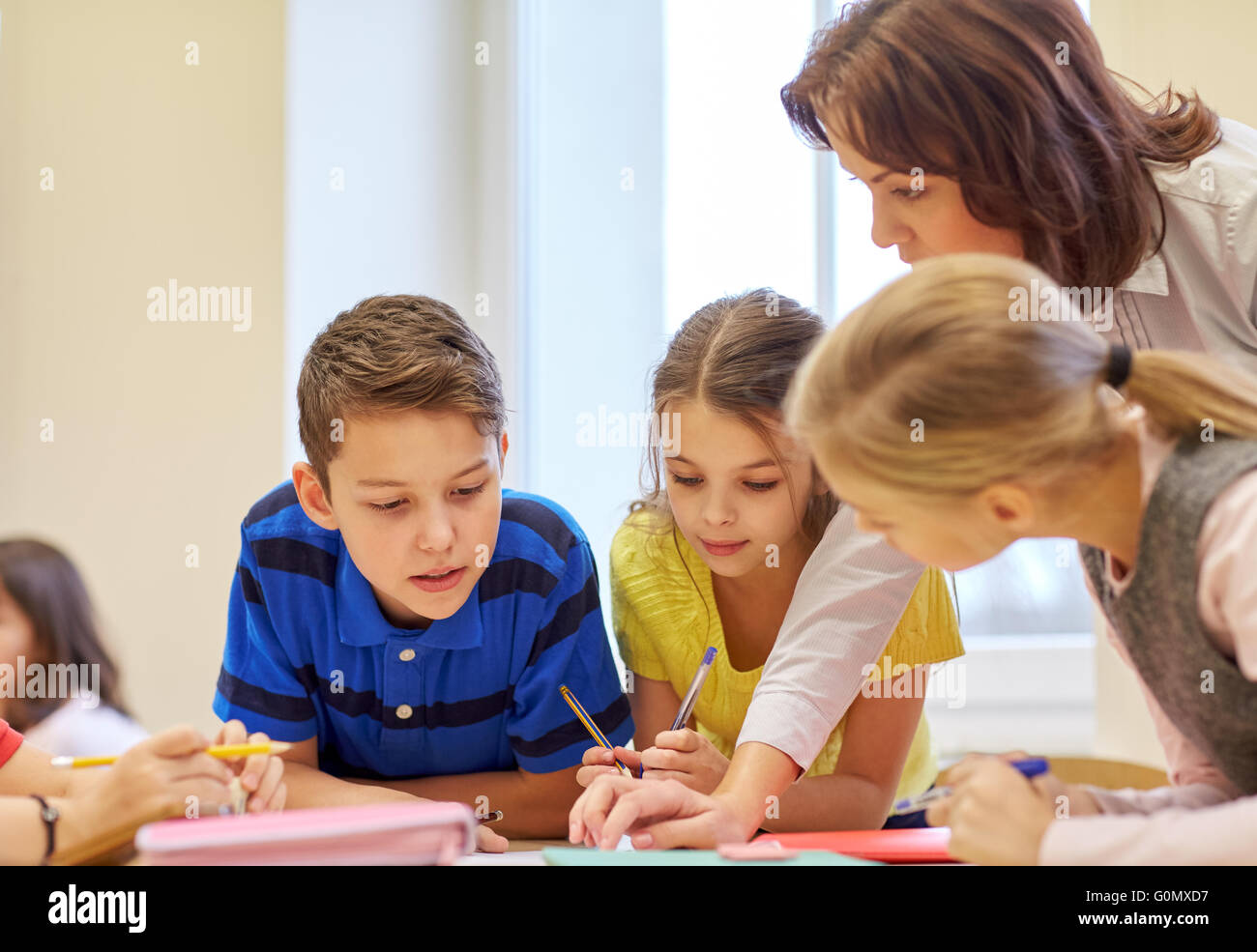 group of school kids writing test in classroom Stock Photo - Alamy