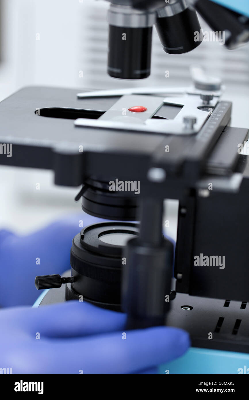 close up of hands with microscope and blood sample Stock Photo - Alamy