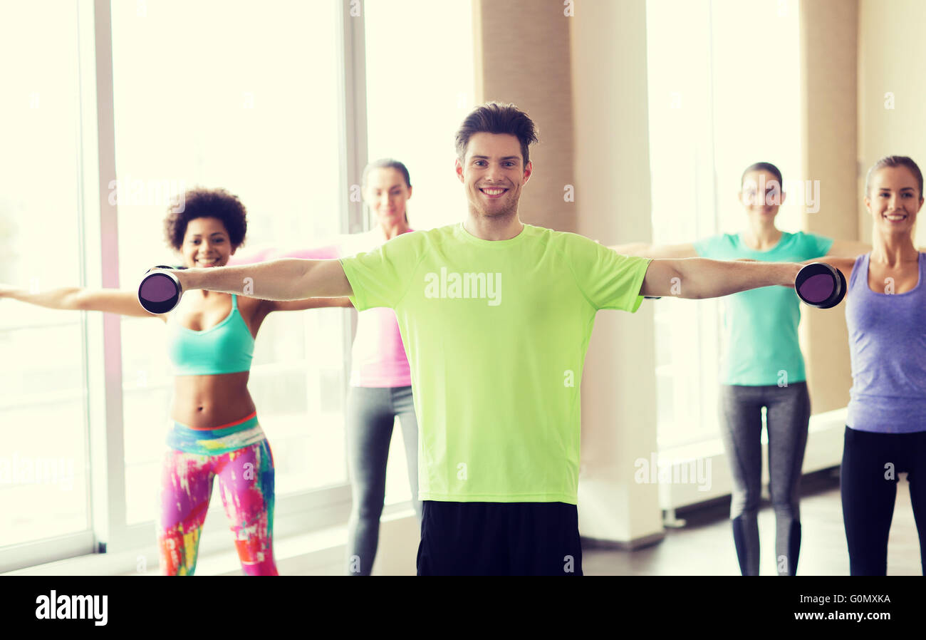 group of smiling people working out with dumbbells Stock Photo - Alamy