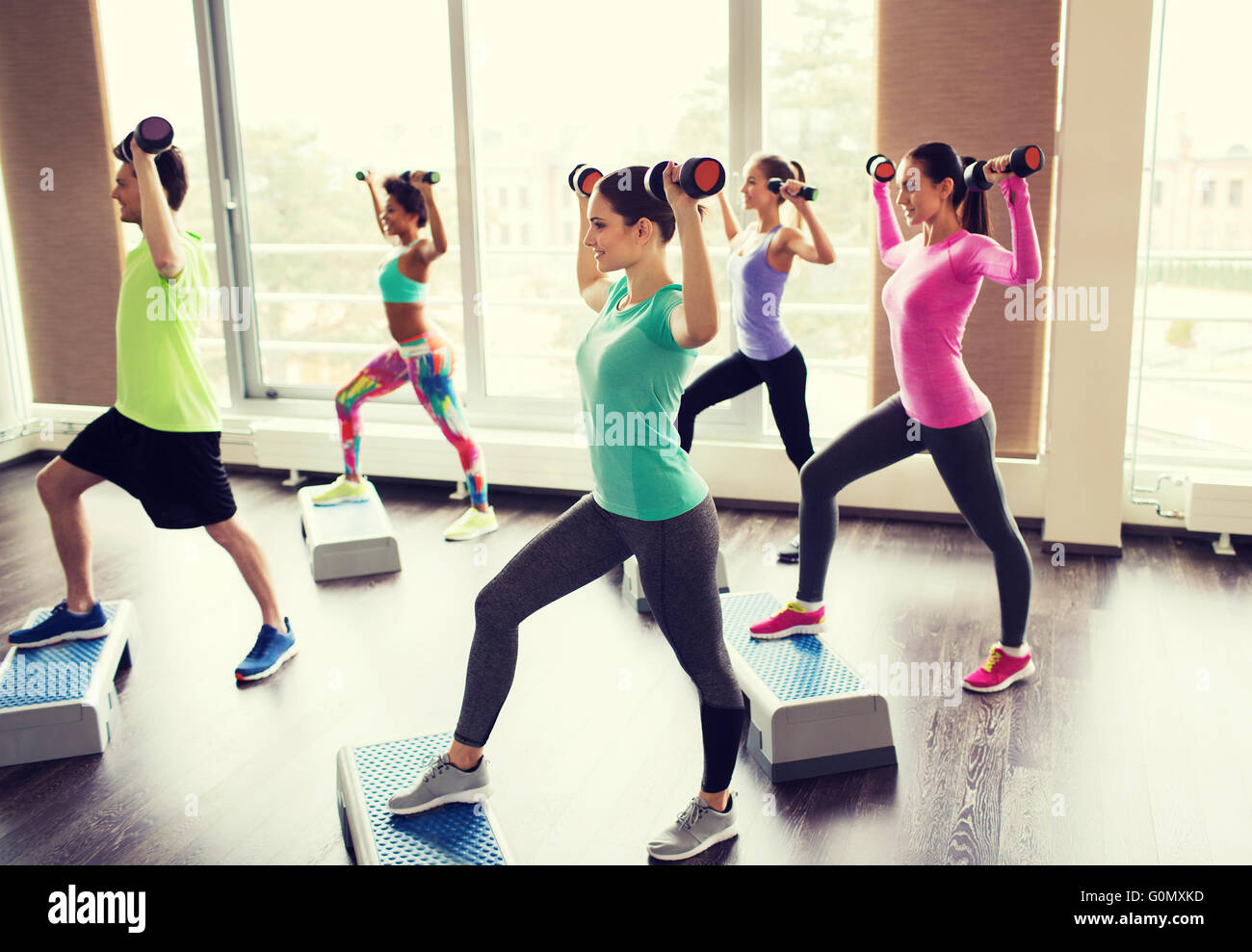group of people with dumbbells and steppers Stock Photo - Alamy