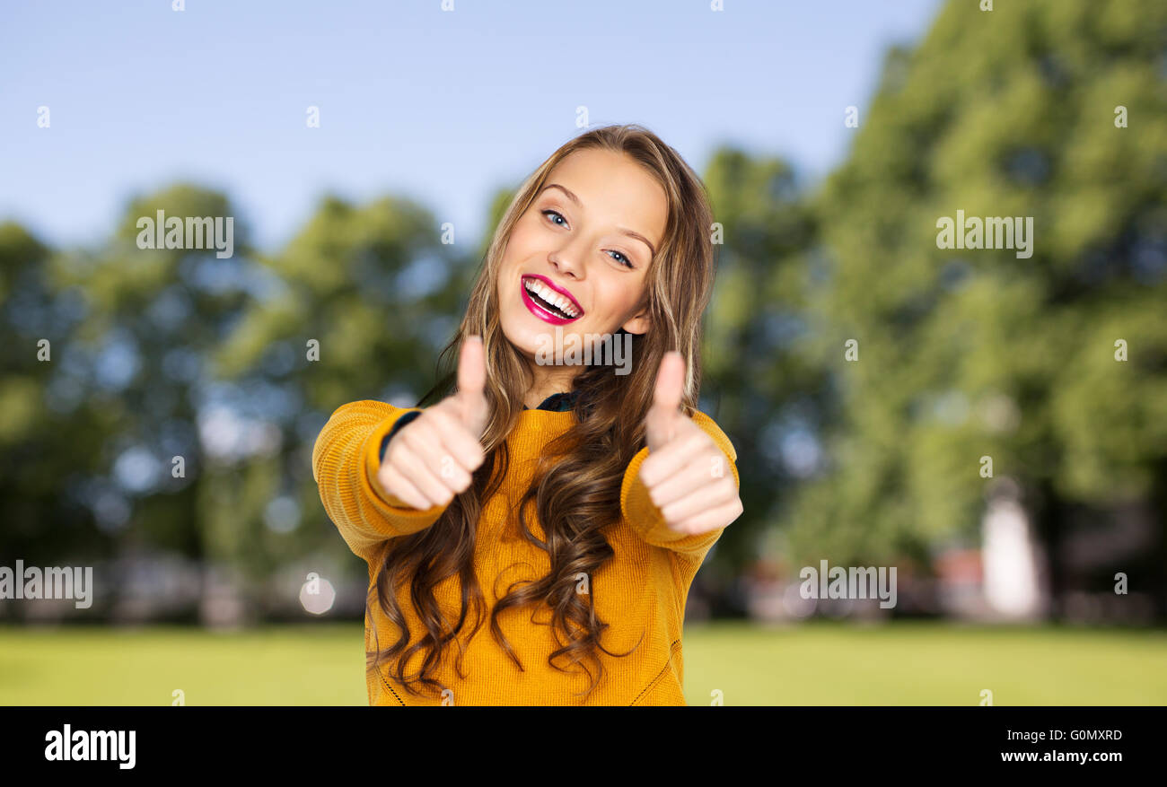 happy young woman or teen girl showing thumbs up Stock Photo - Alamy