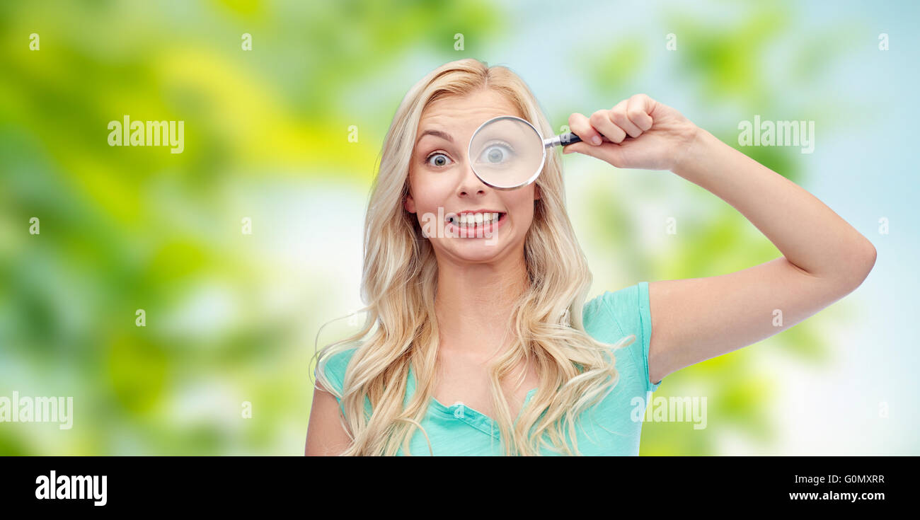 happy young woman with magnifying glass Stock Photo - Alamy