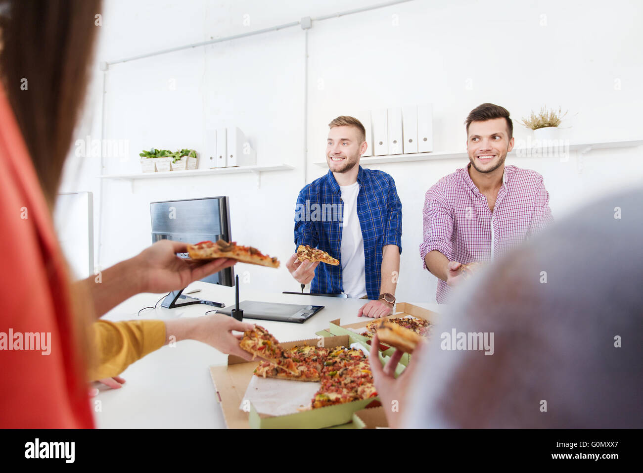 happy business team eating pizza in office Stock Photo - Alamy