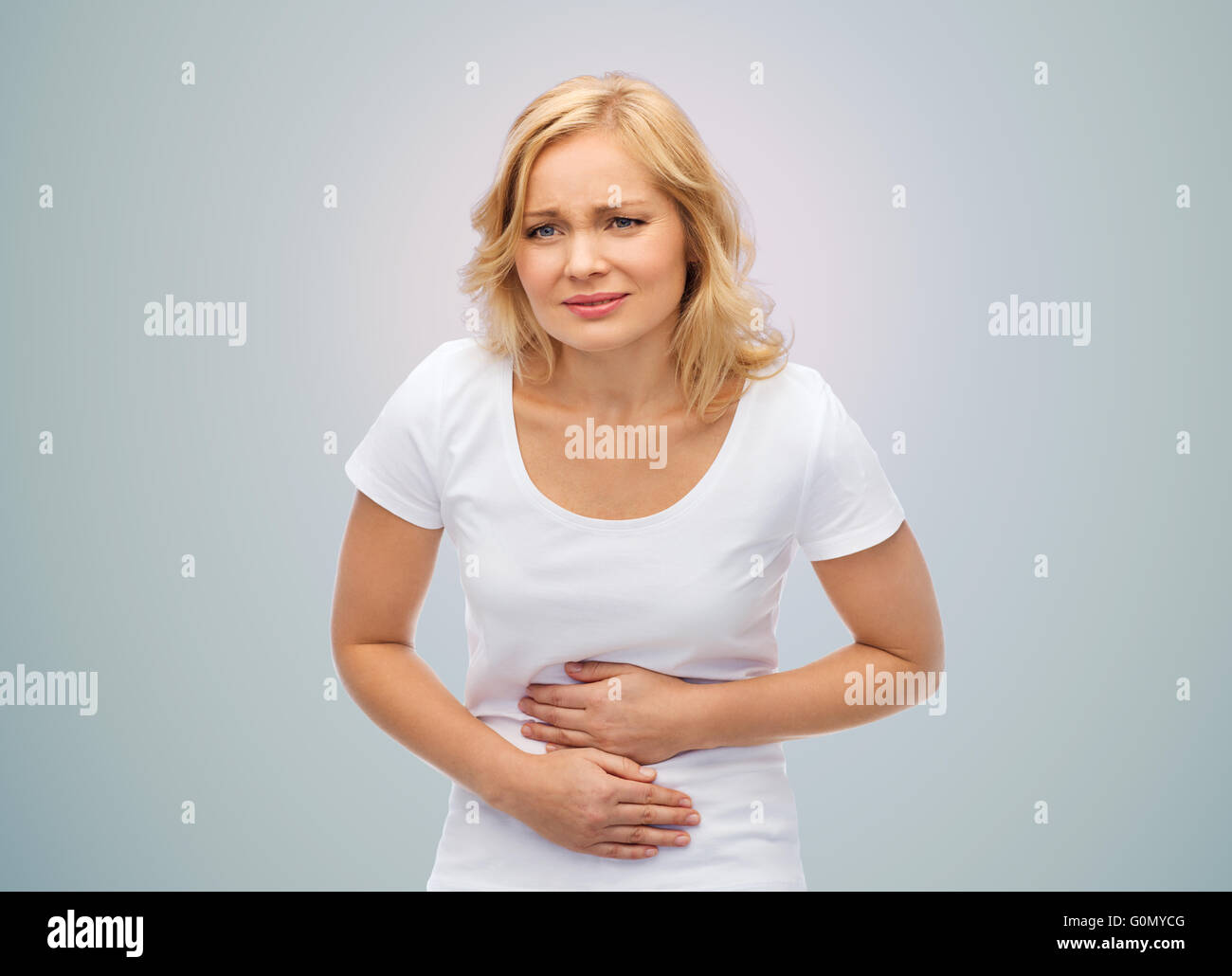 unhappy woman suffering from stomach ache Stock Photo - Alamy