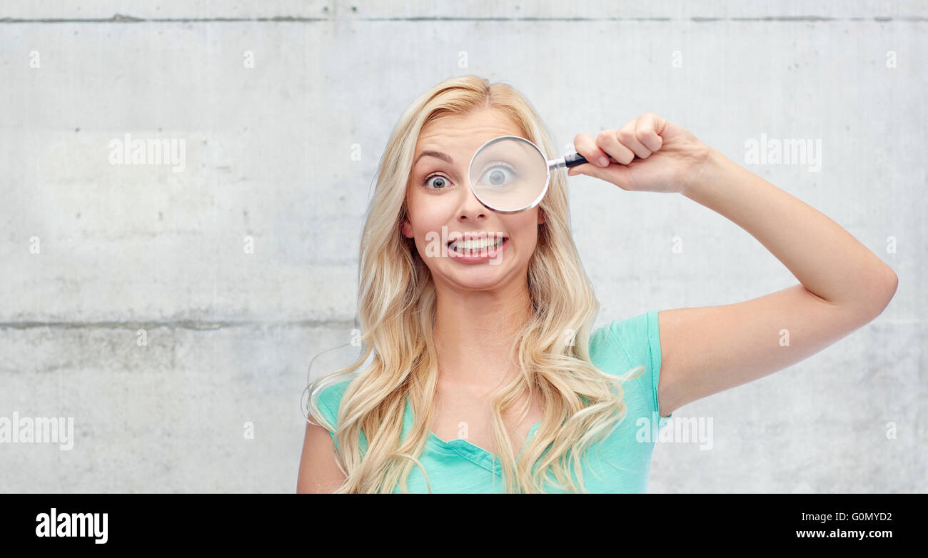 happy young woman with magnifying glass Stock Photo - Alamy