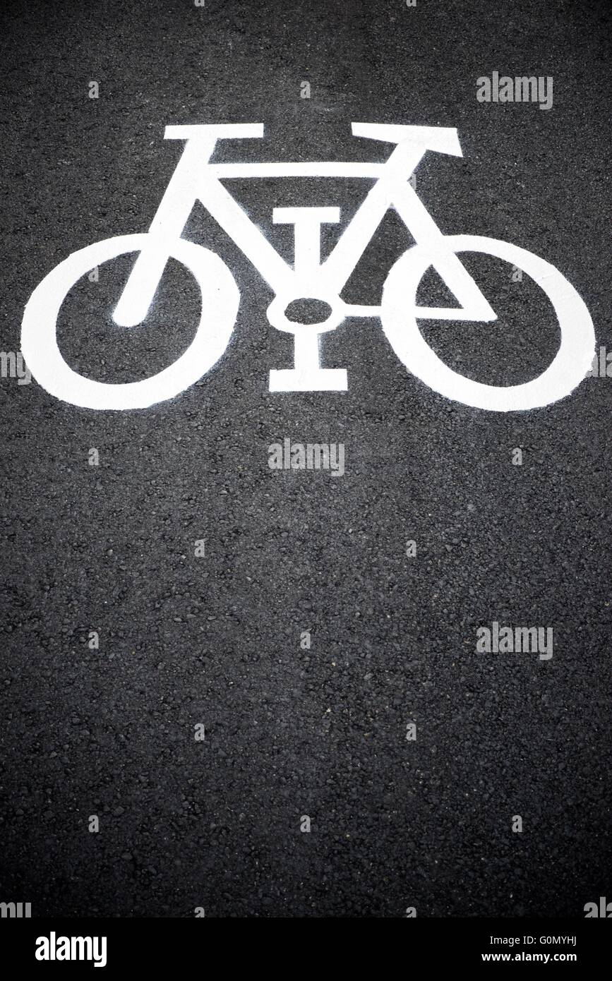 Bike lane sign painted on a street Stock Photo - Alamy