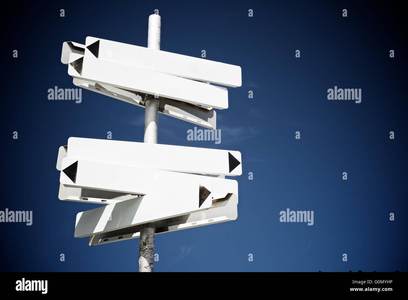 Directional signals in a pole with blue sky Stock Photo - Alamy
