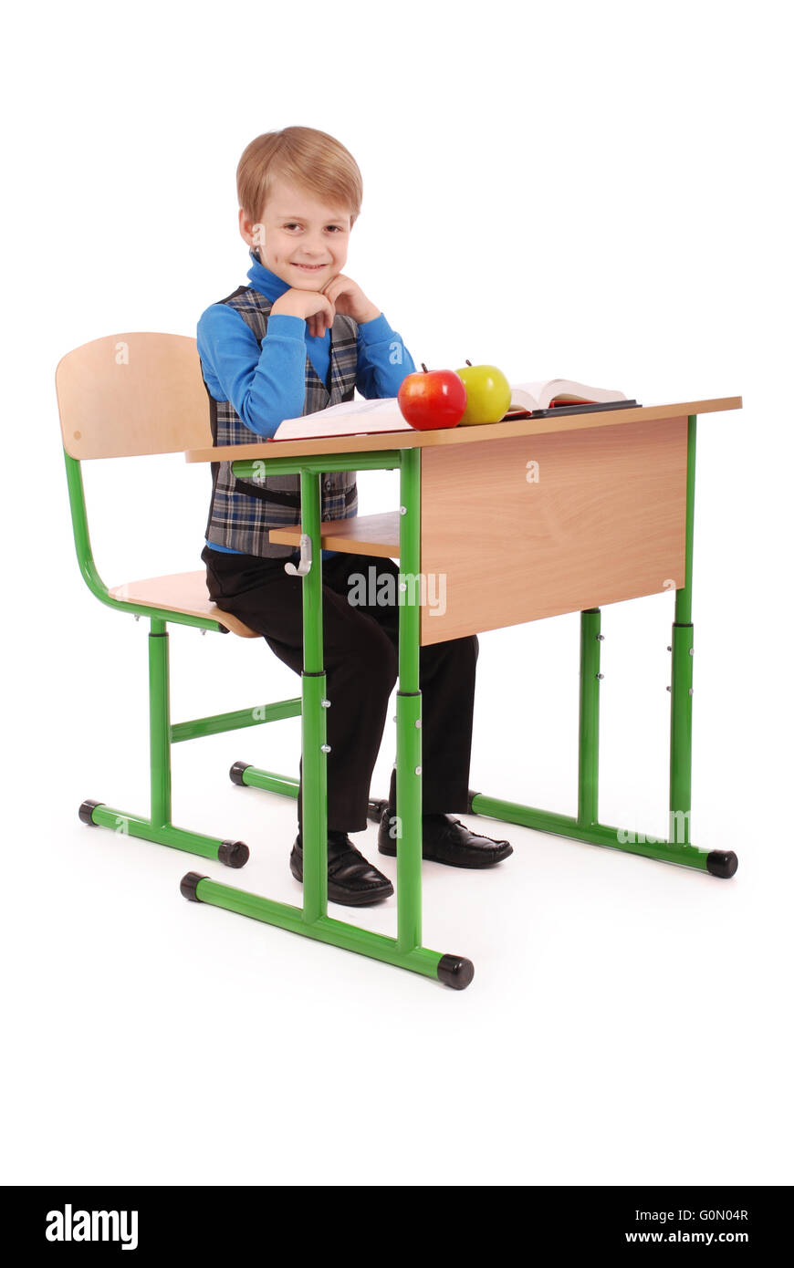 Boy sitting at a school desk isolated on white Stock Photo - Alamy