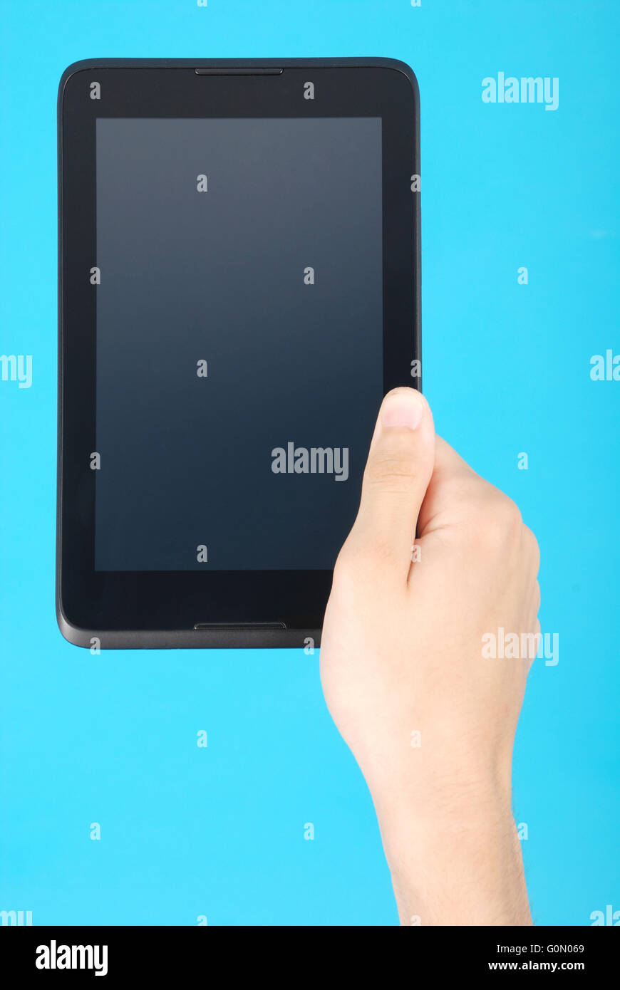 Male hand holding a touchscreen isolated on blue background Stock Photo ...