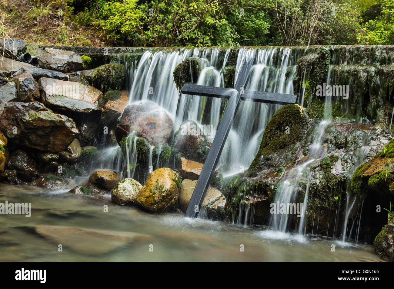 Water falling down over a black cross Stock Photo - Alamy