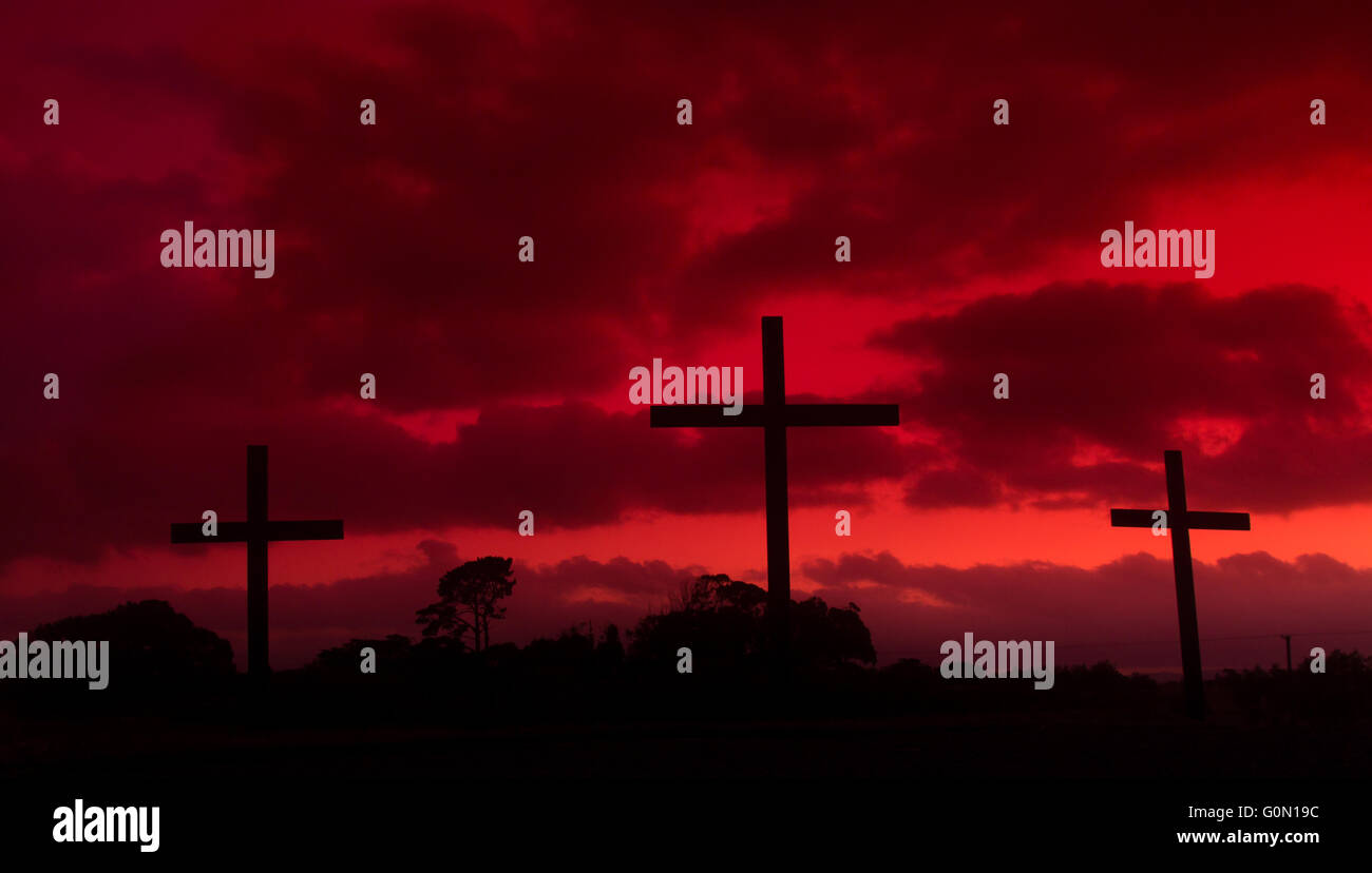 Three crosses with a blood red looking sky behind them Stock Photo - Alamy