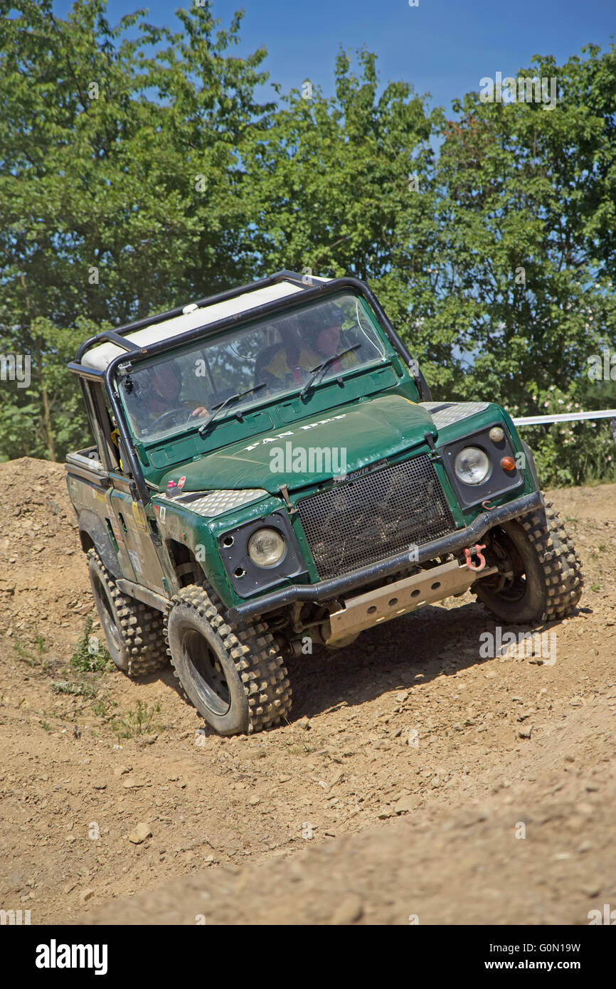 Green off-road car is in the terrain Stock Photo - Alamy