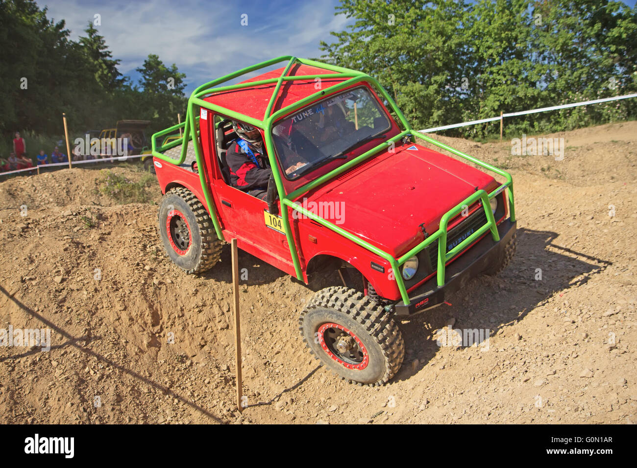 Small red off road car on rough terrain Stock Photo - Alamy