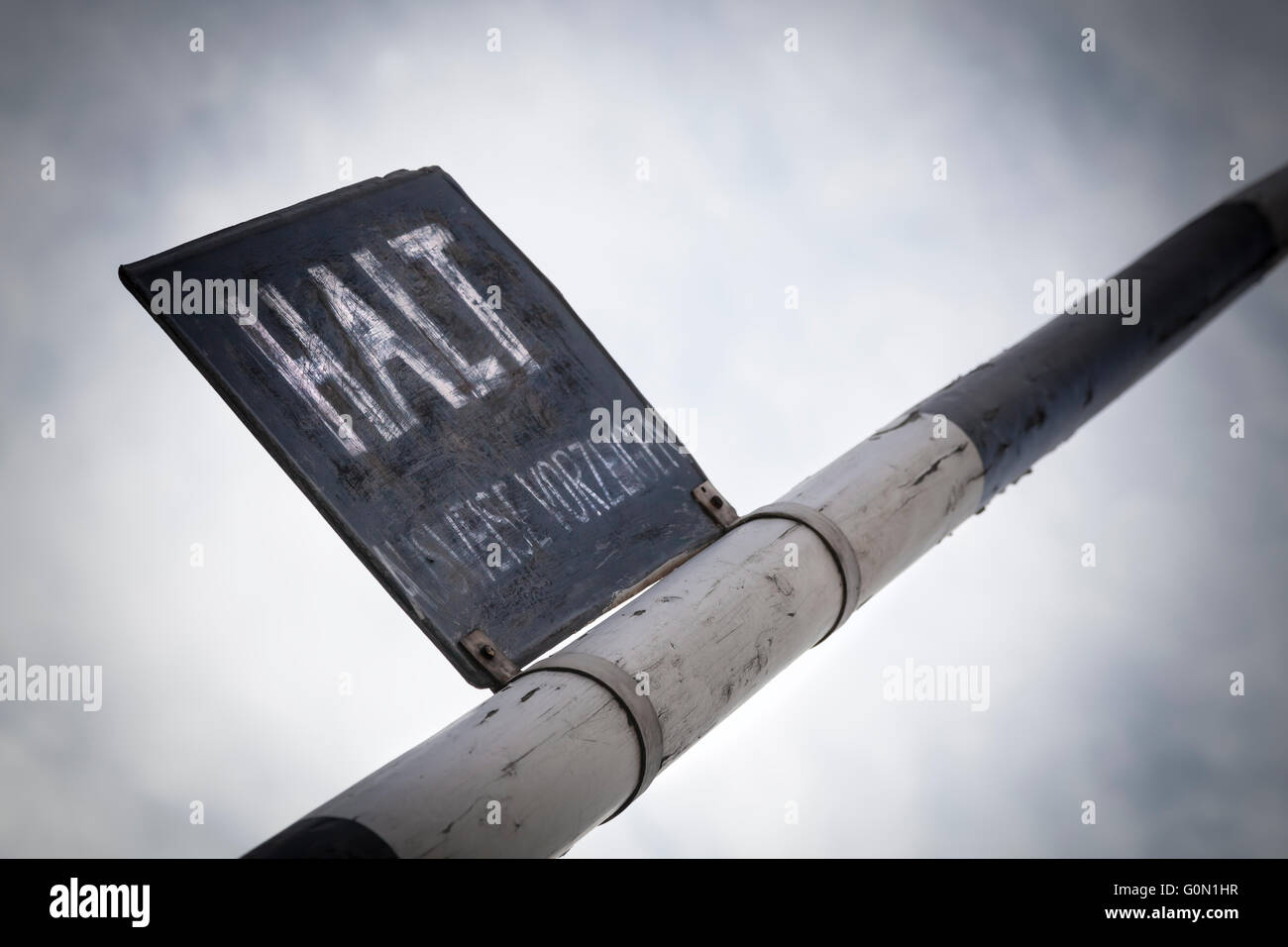 A halt sign attached to a barrier at the entrance to the Auschwitz ...