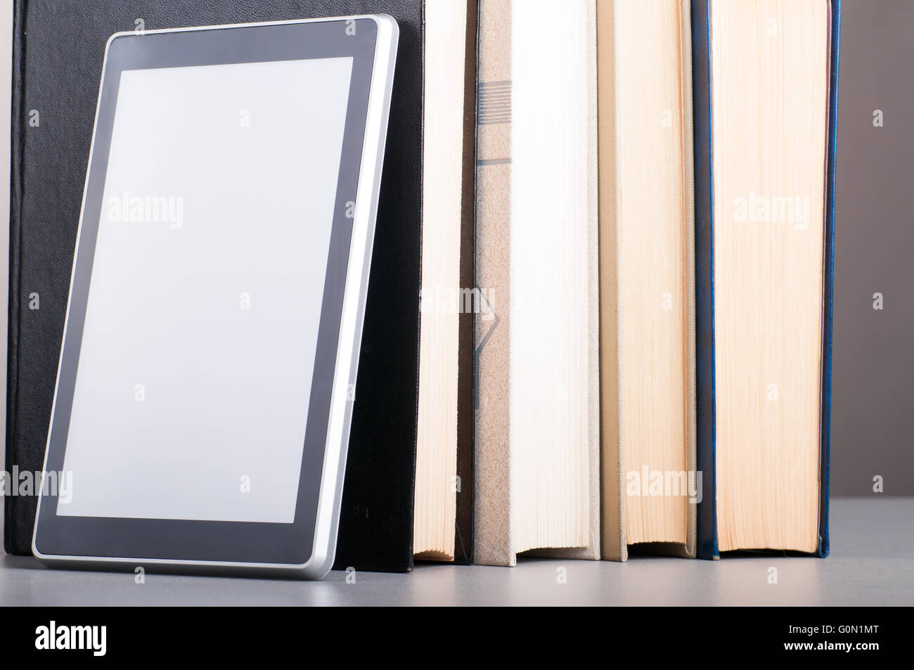 Books and tablet Stock Photo - Alamy