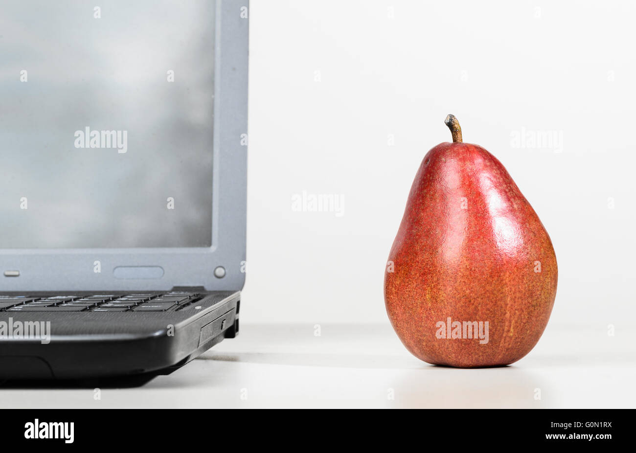 laptop with red pear Stock Photo - Alamy