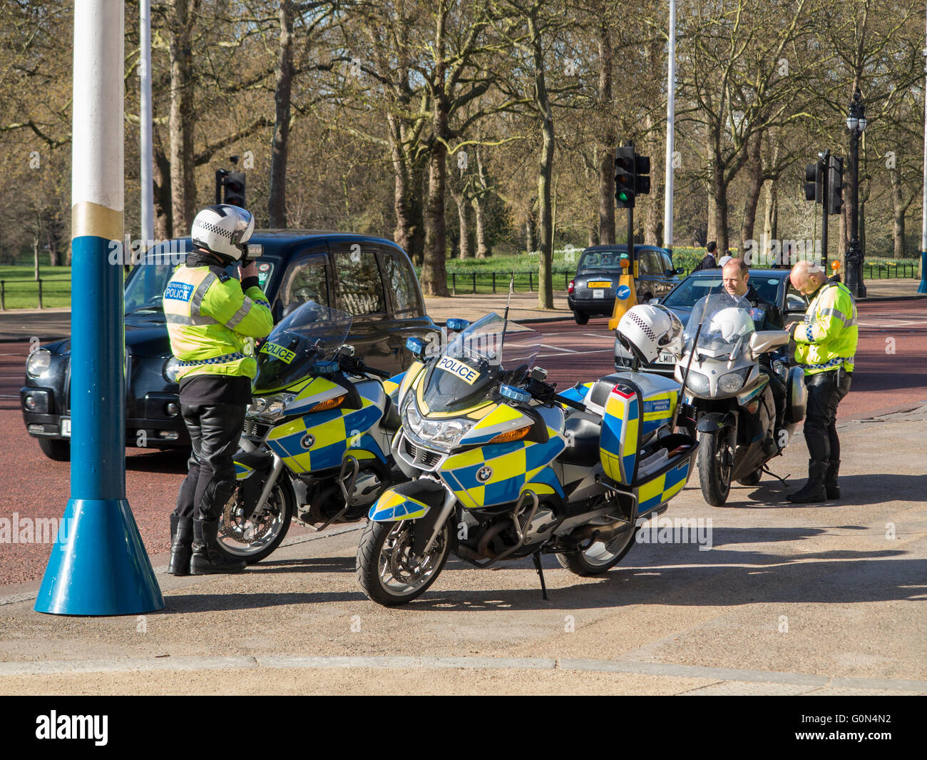 A policeman checks for speeding cars on the Mall in central London ...
