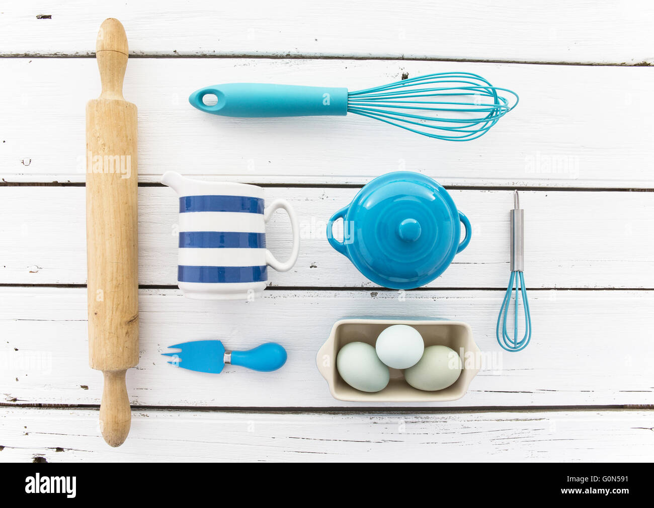 Blue Kitchen Tools on a rustic white wooden table top Stock Photo - Alamy