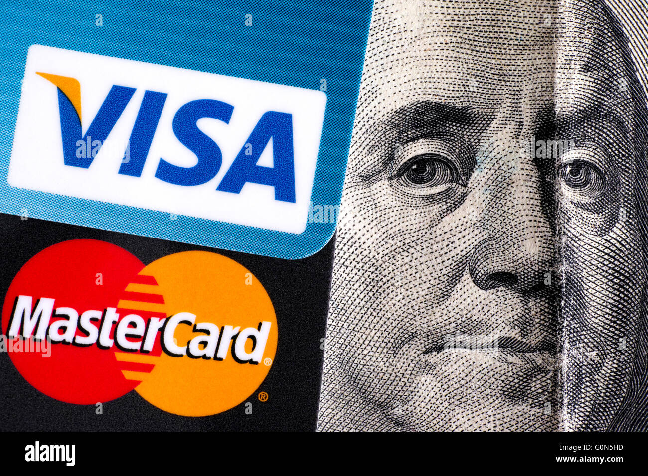 Visa and MasterCard logo on credit cards on one hundred dollar bill ...