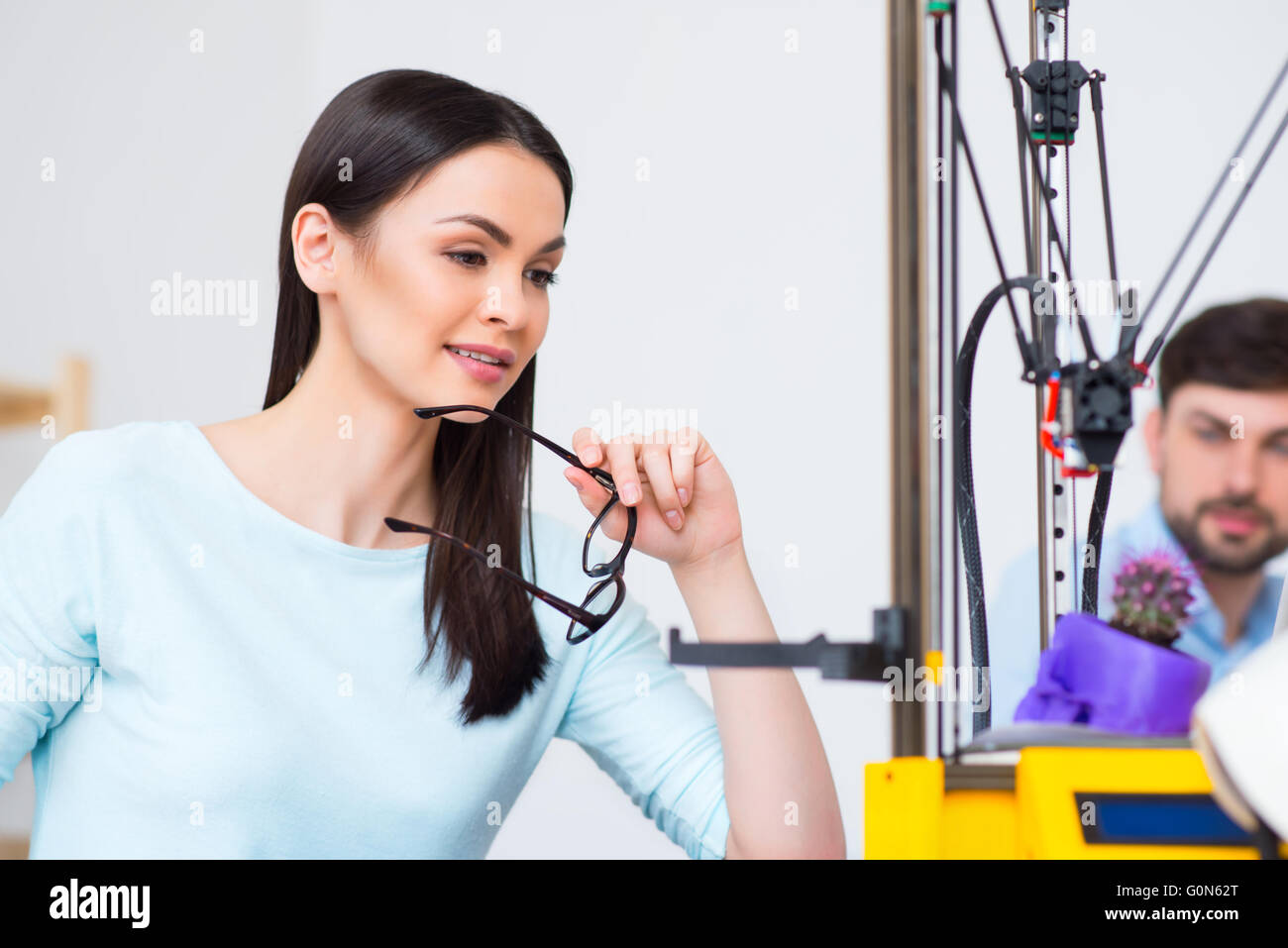 Pleasant woman using 3d printer Stock Photo - Alamy