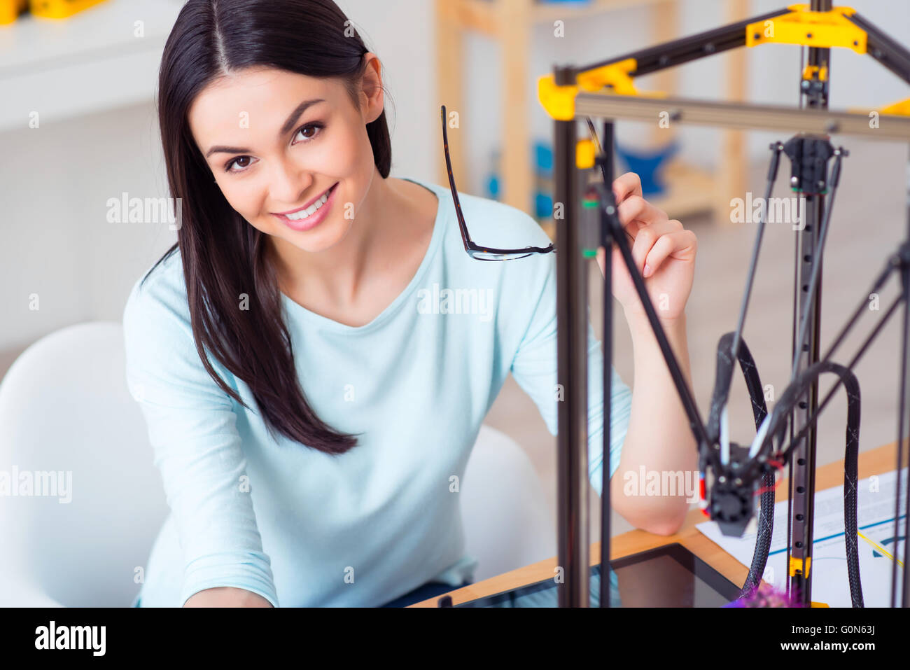 Pleasant woman using 3d printer Stock Photo - Alamy
